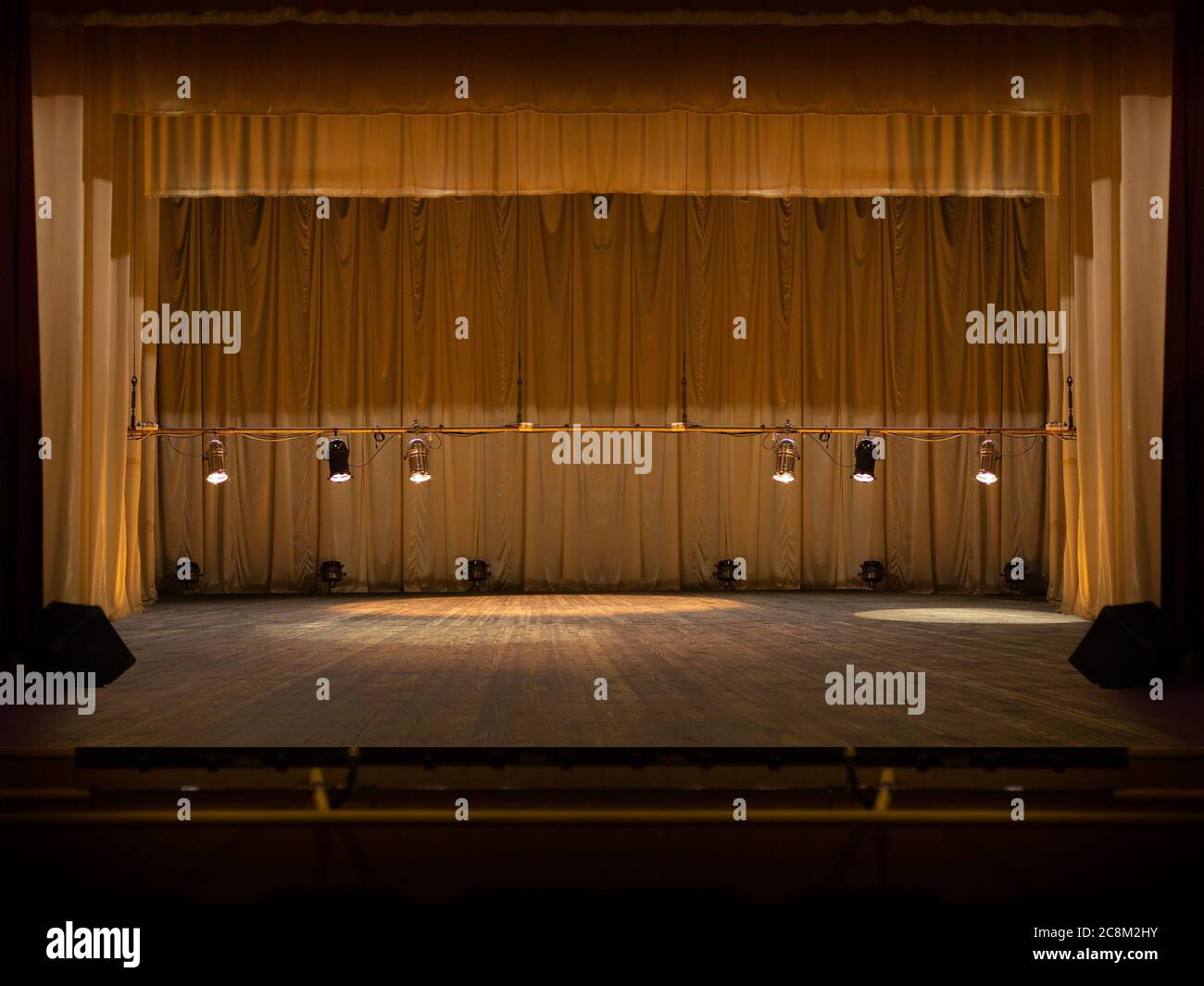 An empty stage of the theater, lit by spotlights and smoke before the ...