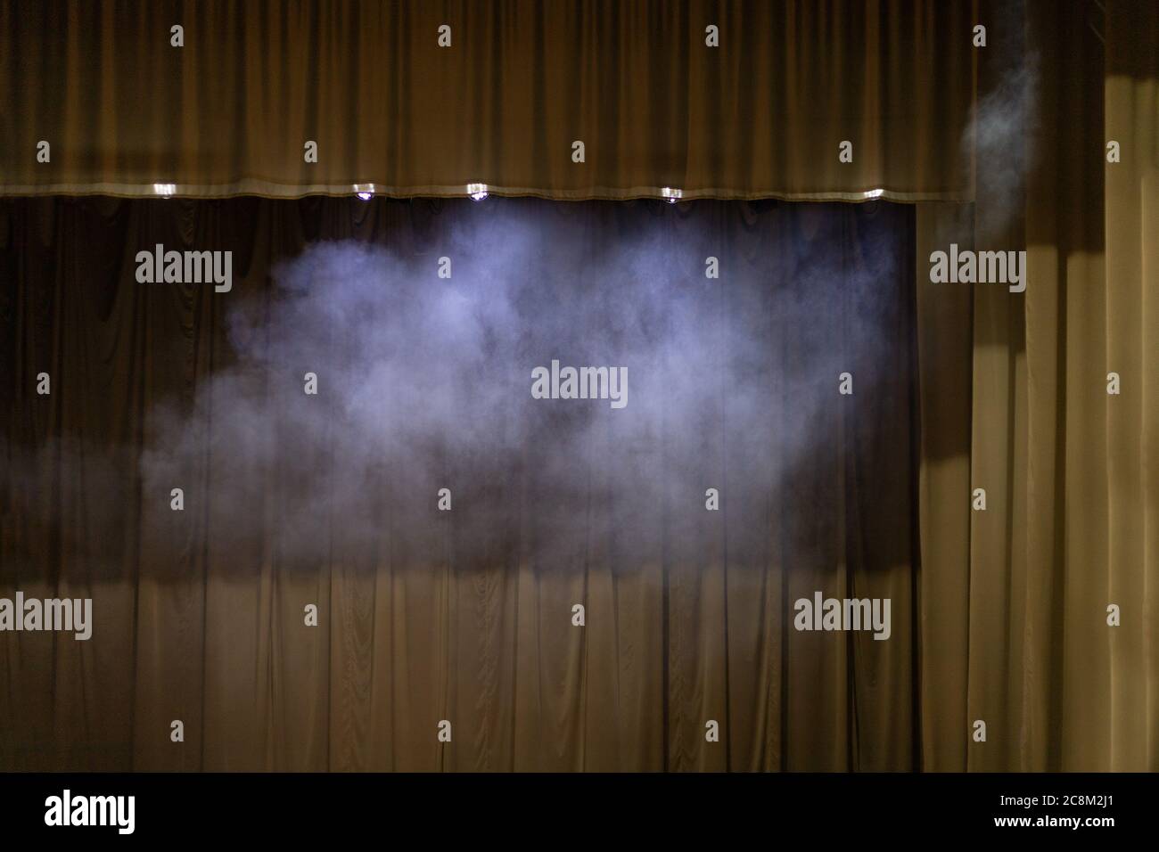 Theater stage, colored puffs of smoke in stage light Stock Photo - Alamy