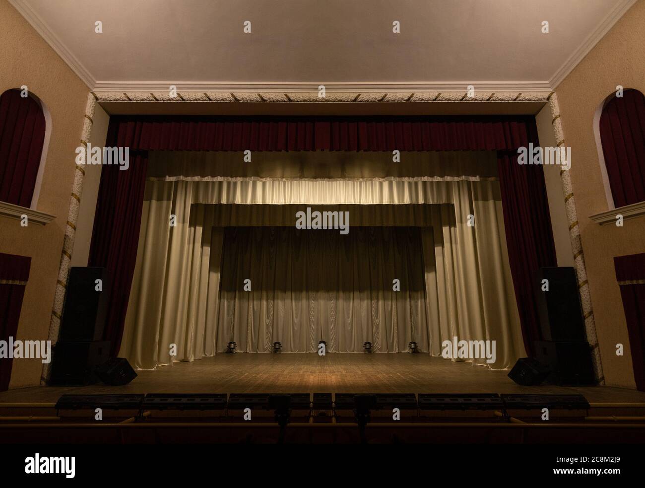 An empty stage of the theater, lit by spotlights and smoke before the ...