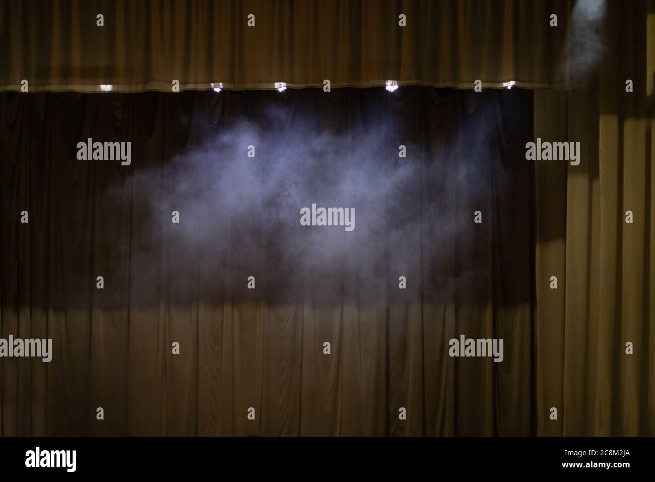 Theater stage, colored puffs of smoke in stage light Stock Photo - Alamy