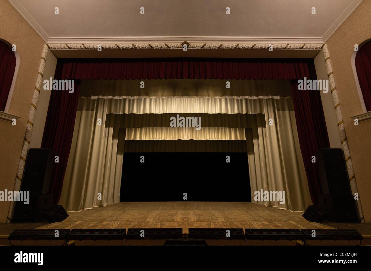 An empty stage of the theater, lit by spotlights and smoke before the ...