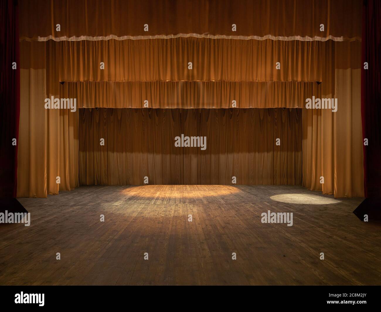 An empty stage of the theater, lit by spotlights and smoke before the ...