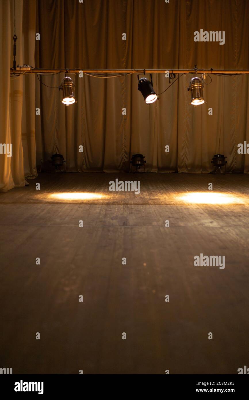 An empty stage of the theater, lit by spotlights and smoke before the ...