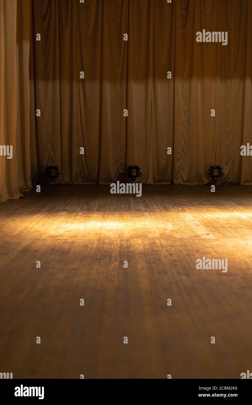 An empty stage of the theater, lit by spotlights and smoke before the ...