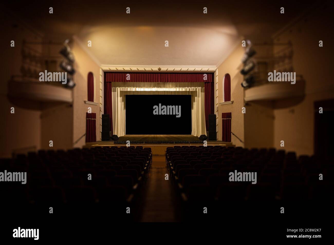 An empty stage of the theater, lit by spotlights and smoke before the ...