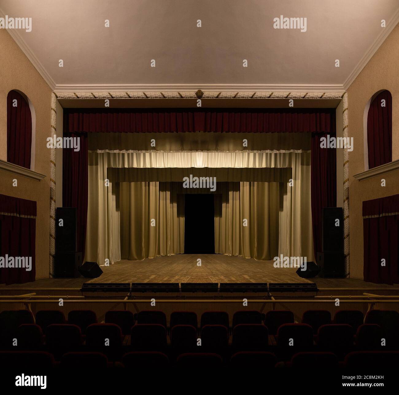 An empty stage of the theater, lit by spotlights and smoke before the ...