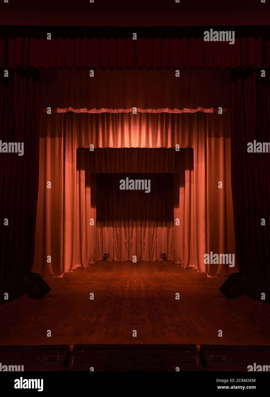 An empty stage of the theater, lit by spotlights and smoke before the ...