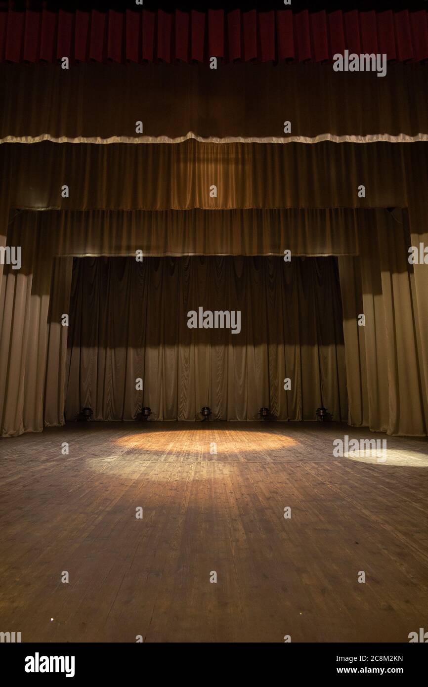 An empty stage of the theater, lit by spotlights and smoke before the ...