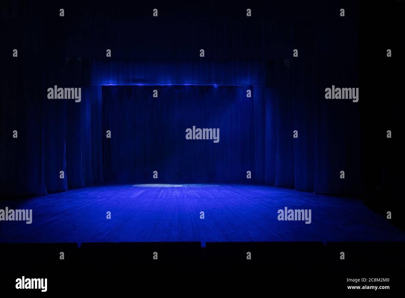 An empty stage of the theater, lit by spotlights and smoke before the ...