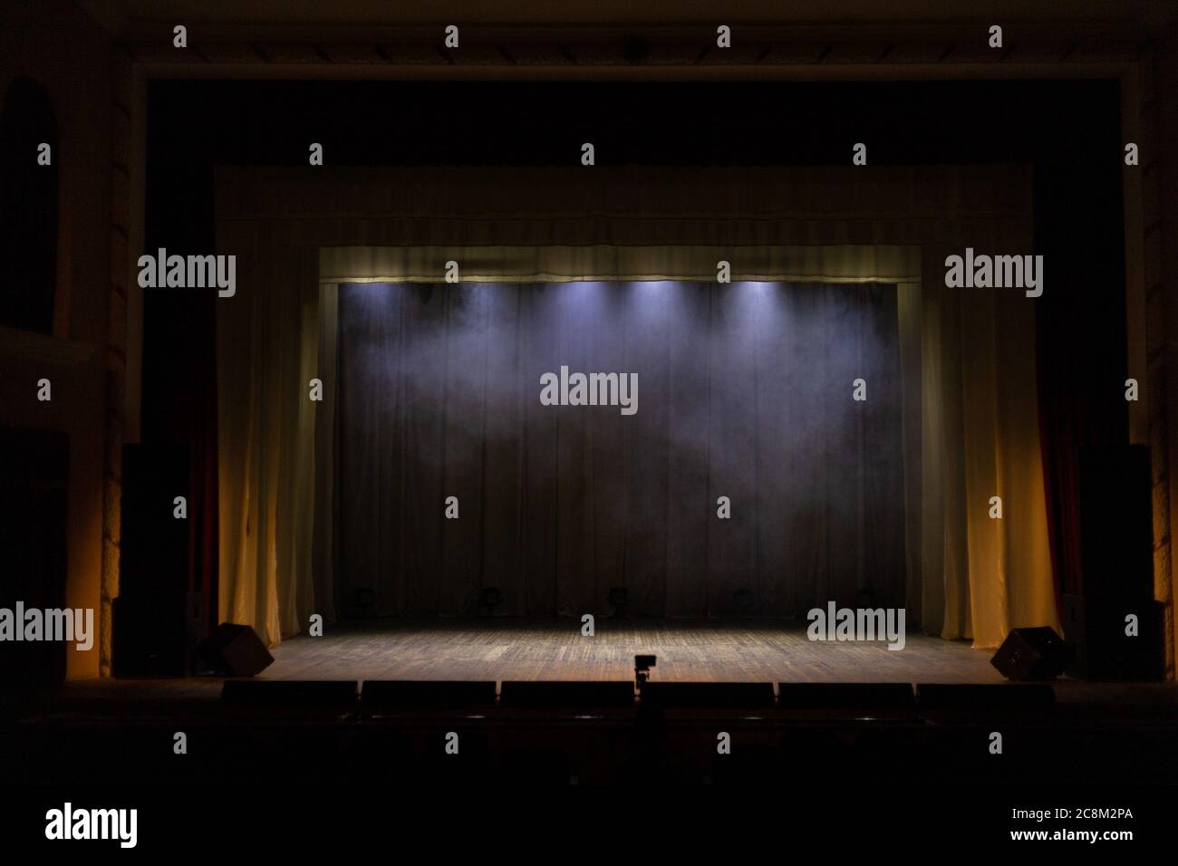 Theater stage, colored puffs of smoke in stage light Stock Photo - Alamy