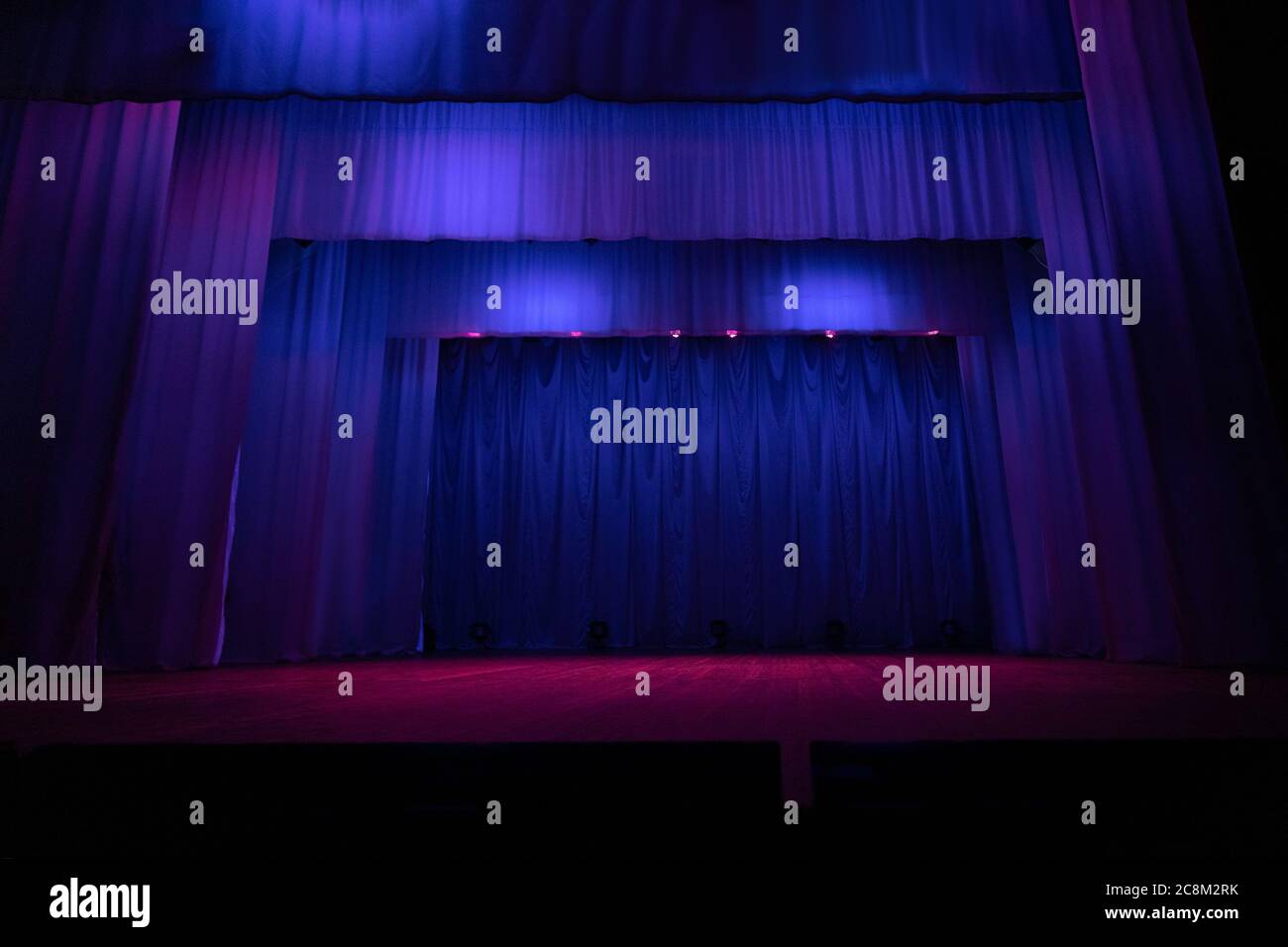 An empty stage of the theater, lit by spotlights and smoke before the ...