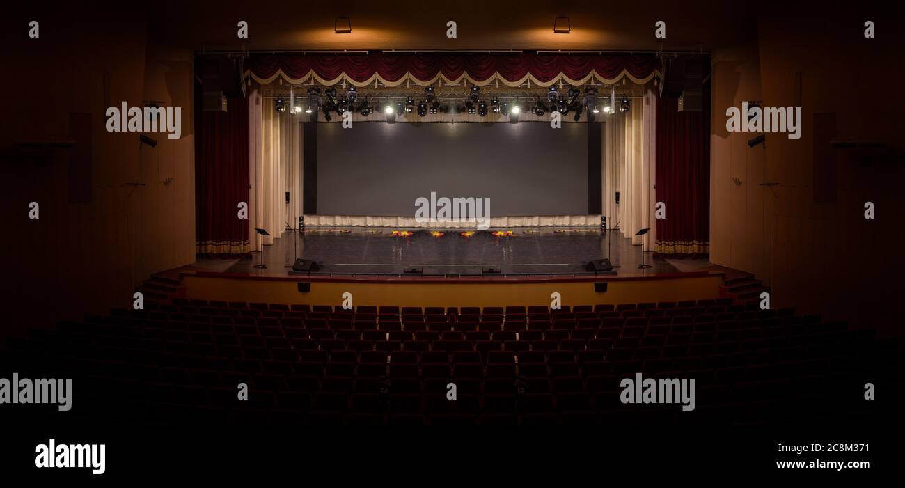 An empty stage of the theater, lit by spotlights and smoke before the ...