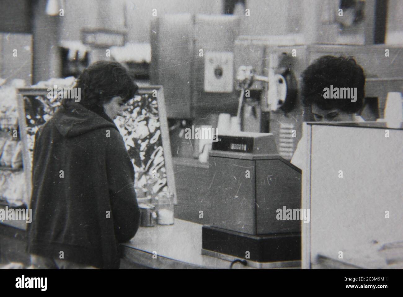 Fine 70s vintage black and white lifestyle photography of a cashier ...