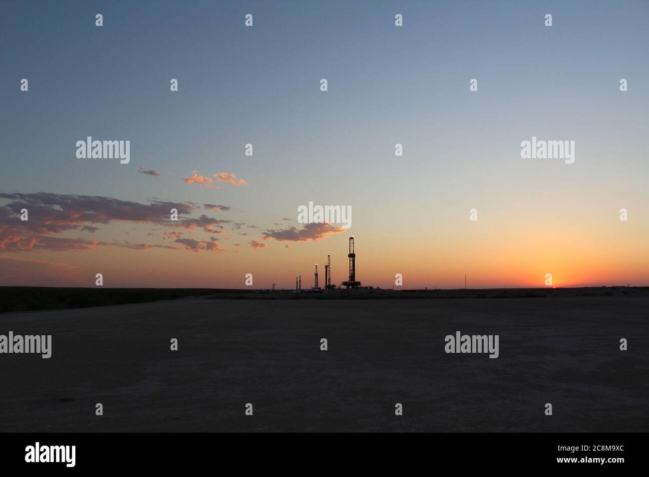 Beautiful sunset over 5 drilling rigs in the Permian Basin of West ...