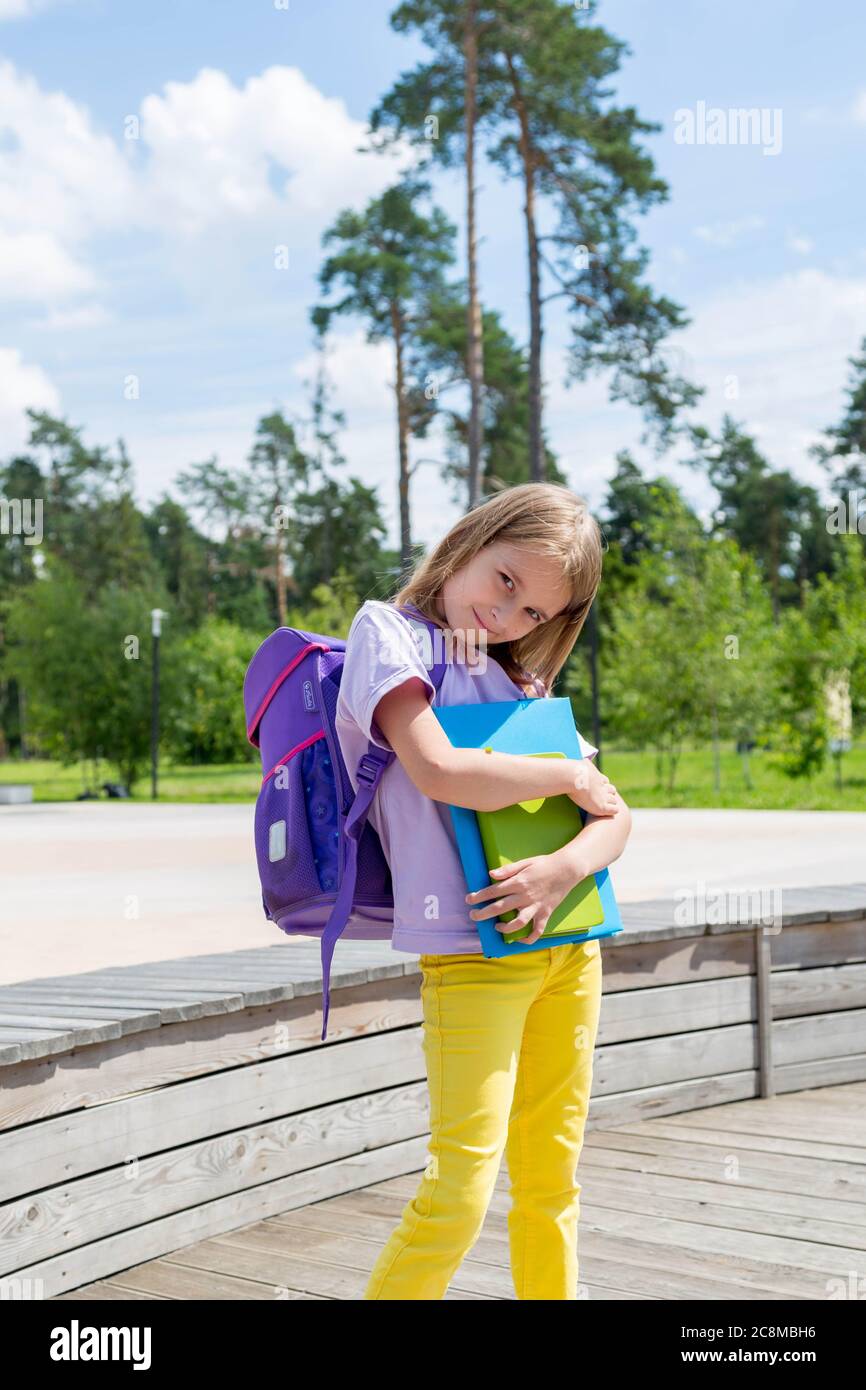 Girl Ready For School With Backpack and Books Stock Photo - Alamy