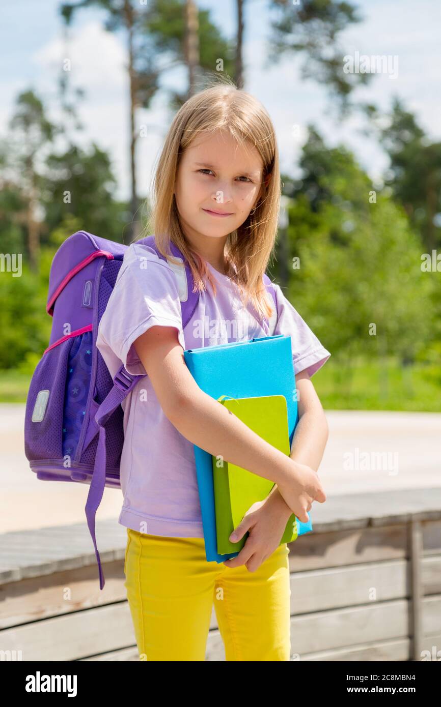 Girl Ready For School With Backpack and Books Stock Photo - Alamy