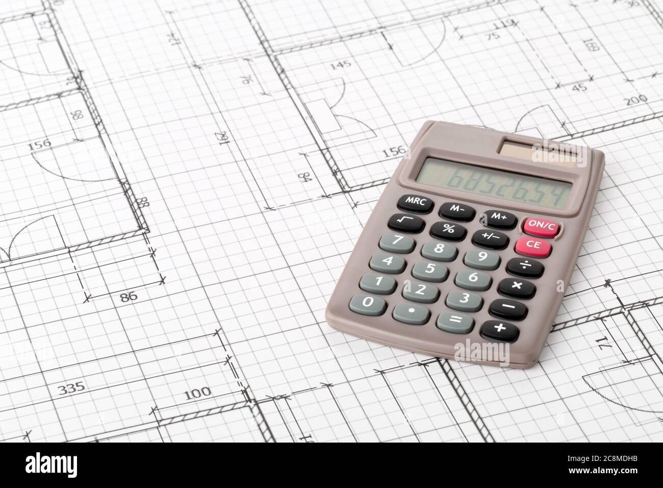 Calculator on architectural house building blueprint plan background ...