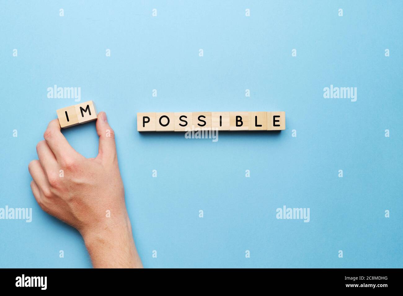 The concept of the possible from the impossible. Hand on a blue ...