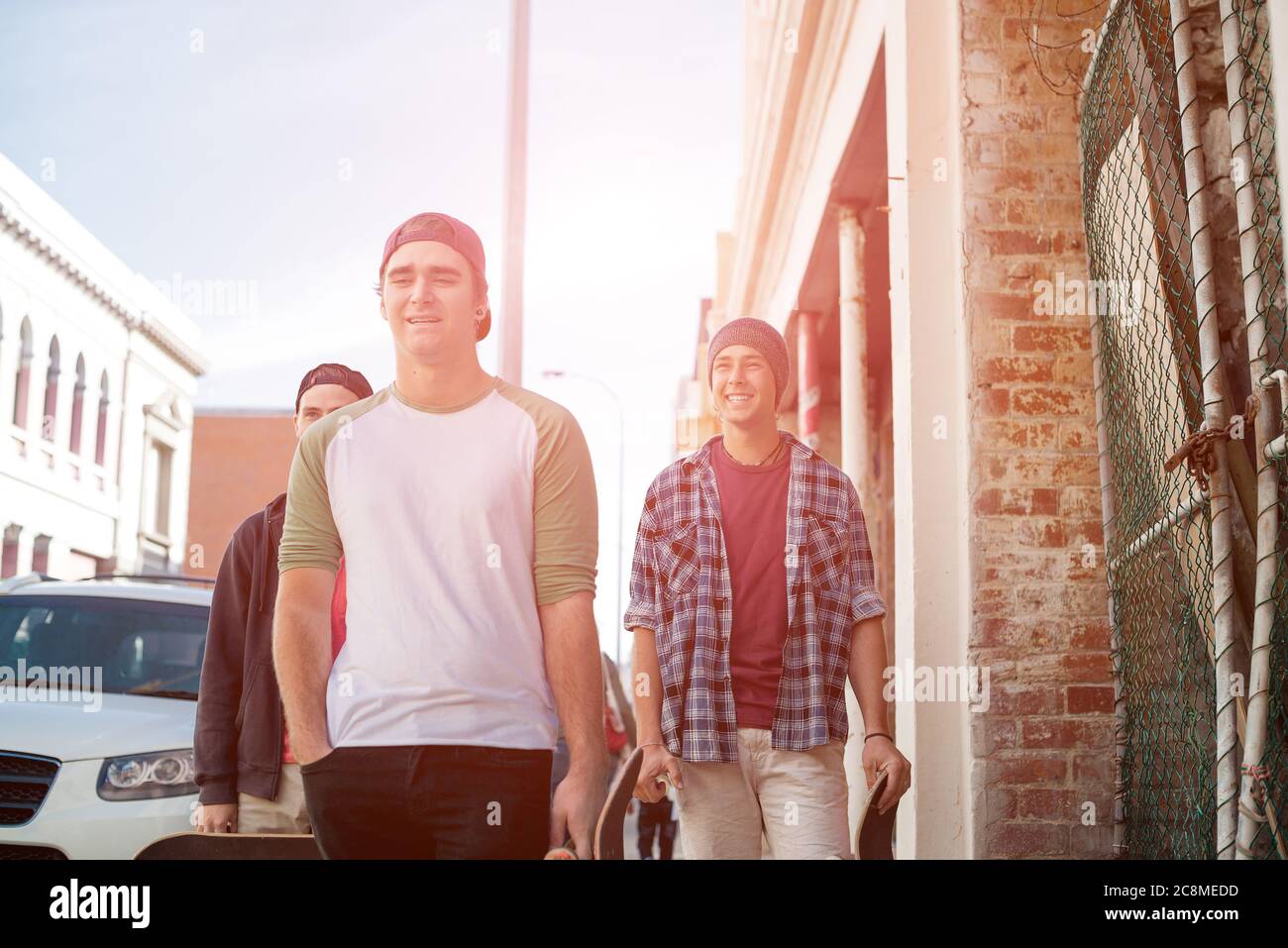 Three guys walking together in hi-res stock photography and images - Alamy
