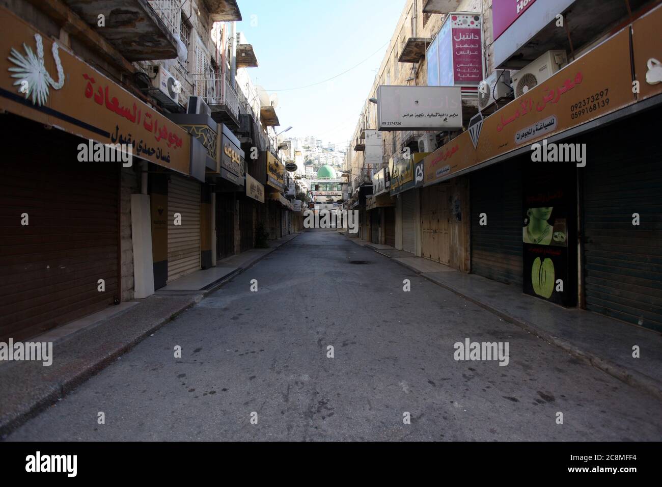 Nablus. 25th July, 2020. Shops are seen closed in an empty street in ...