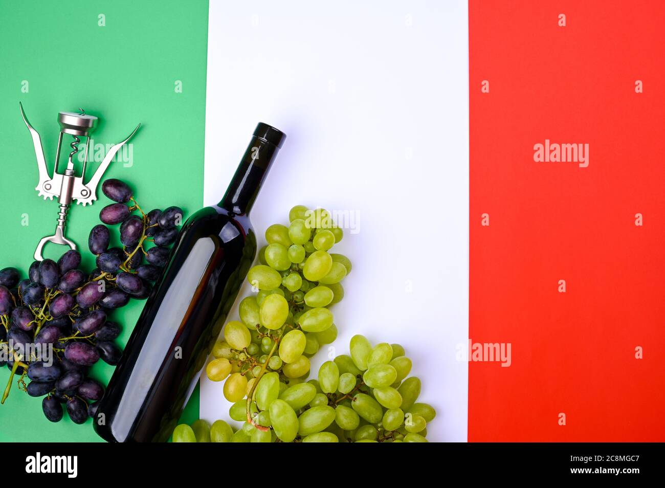 A bottle of wine, grapes, and the flag of Italy close-up. Country ...