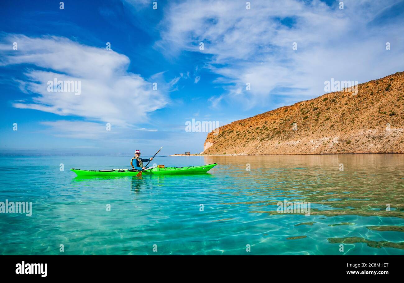 A woman sea kayaking off shore of Isla Espirito Santo, Gulf of ...