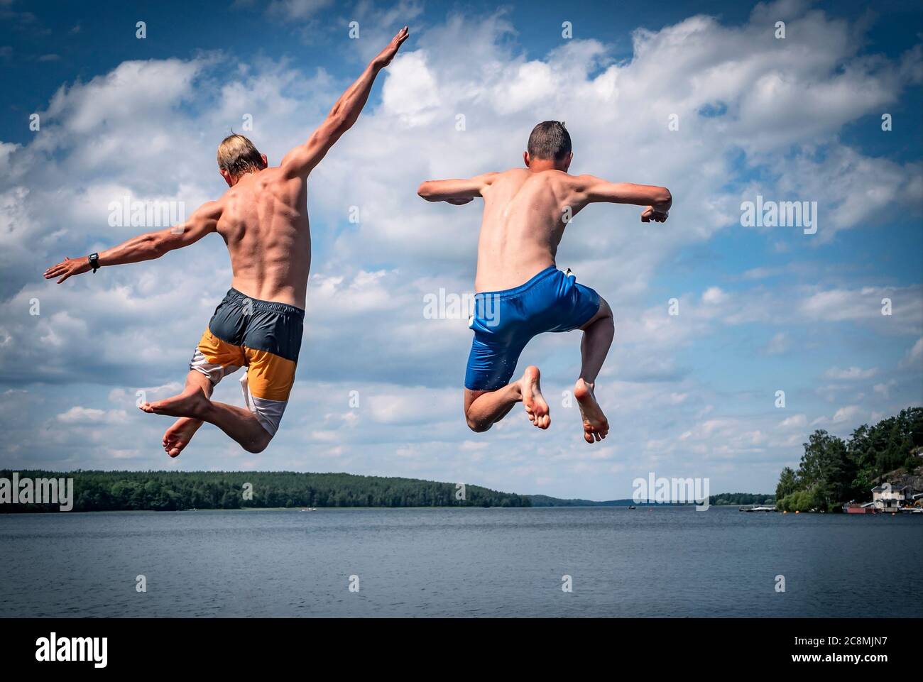 boys jumping into the water Stock Photo - Alamy