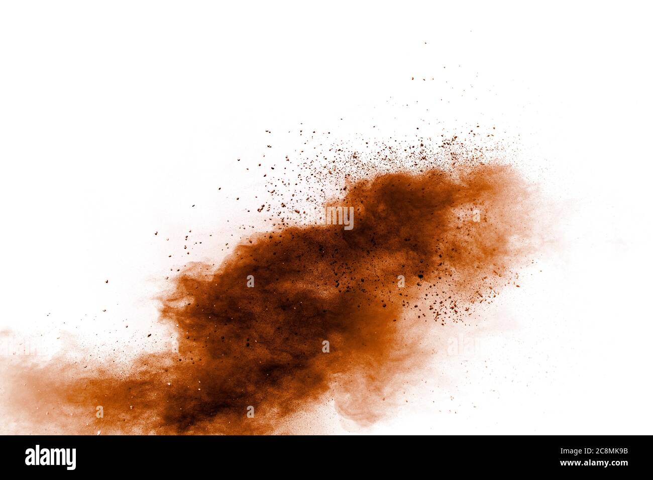 Brown dust exploding cloud.Brown particles splattered on white ...