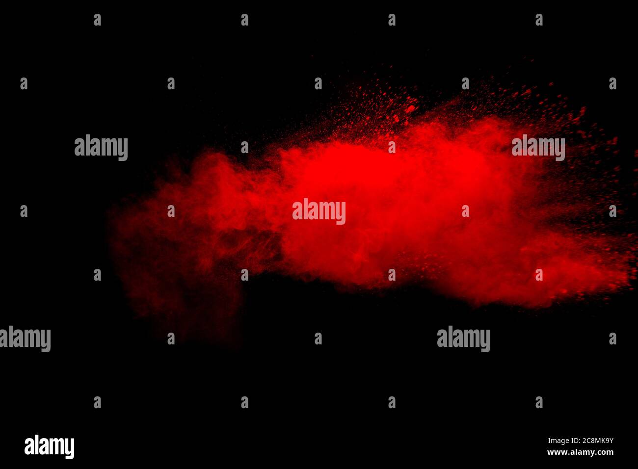 Abstract red dust explosion on black background. Freeze motion of red ...