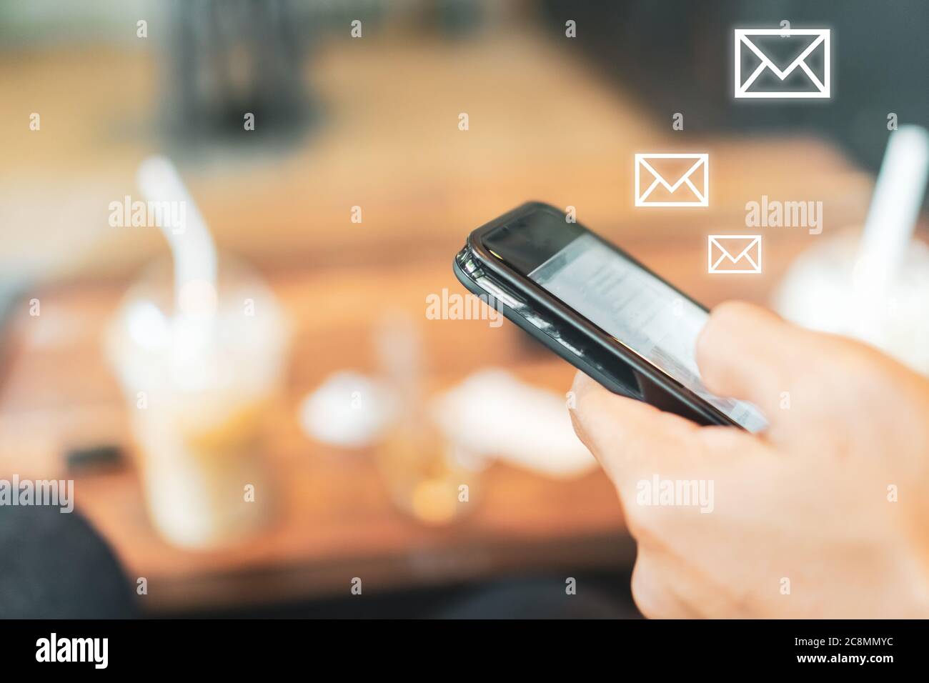 Woman hand using smartphone and it's show email recieve notification ...