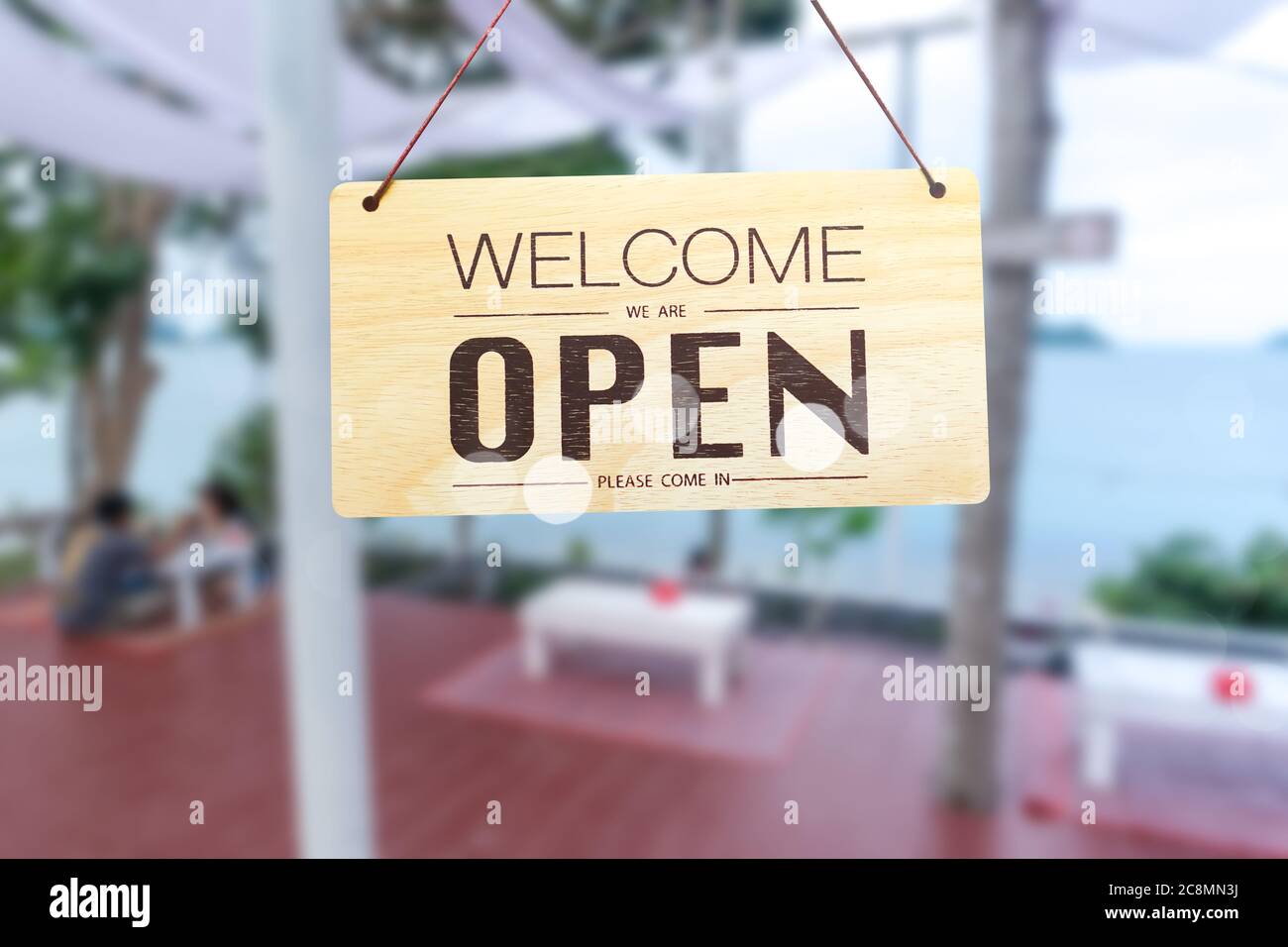 A business sign that says open on cafe or restaurant hang on door at ...