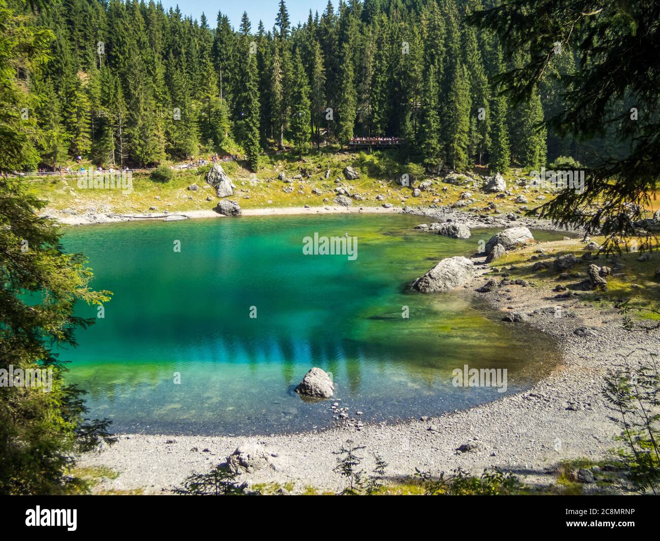The Karersee below the Karerpass at the foot of the Latemar massif in ...
