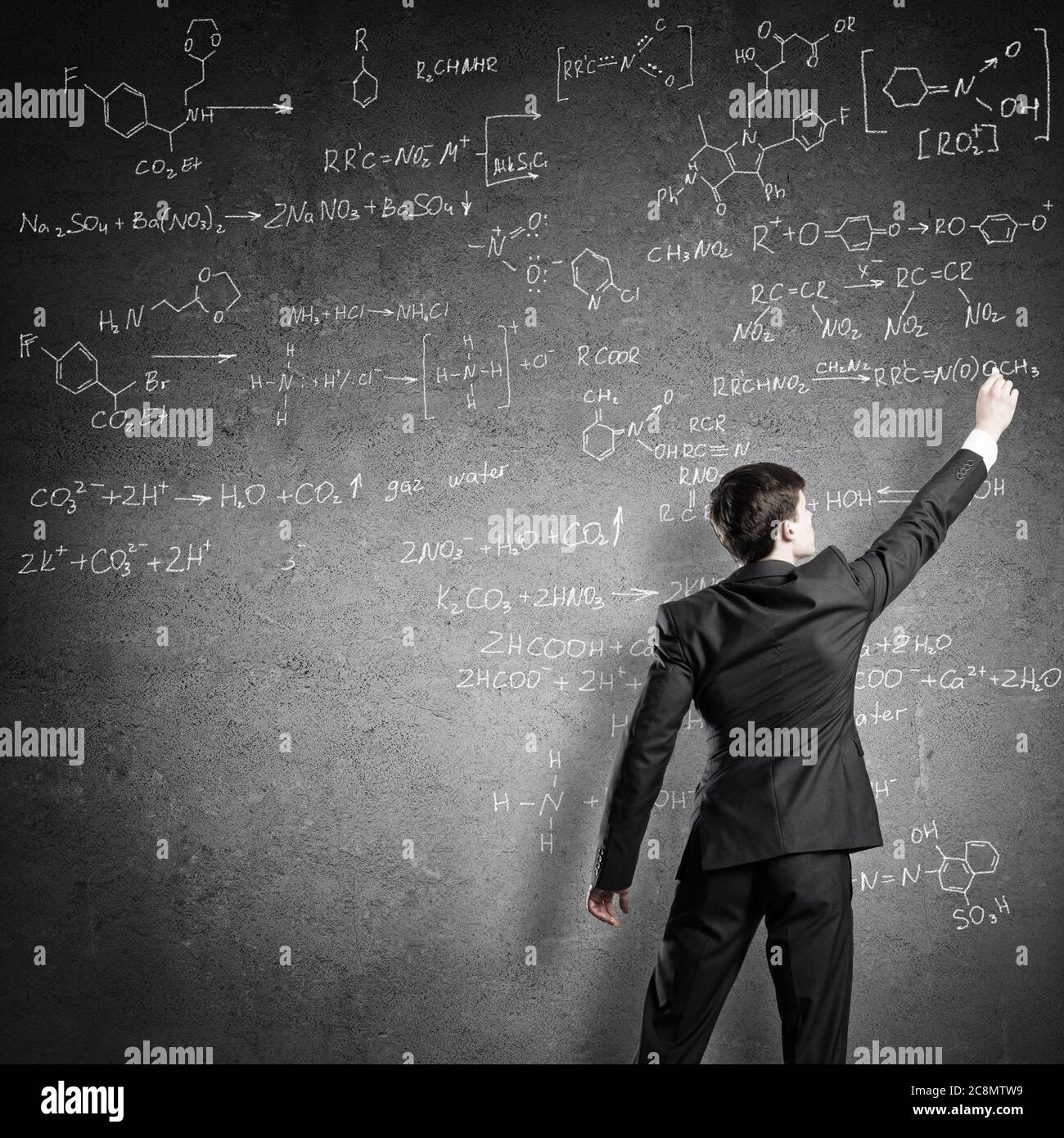 Scientist writing formulas on chalkboard Stock Photo - Alamy