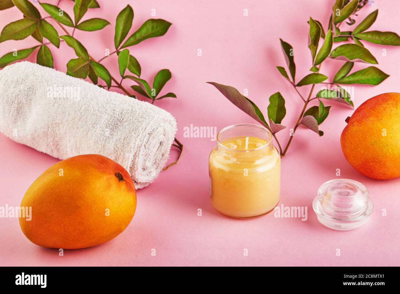 Scented candle for Spa and home with a mango scent and green leaves on ...
