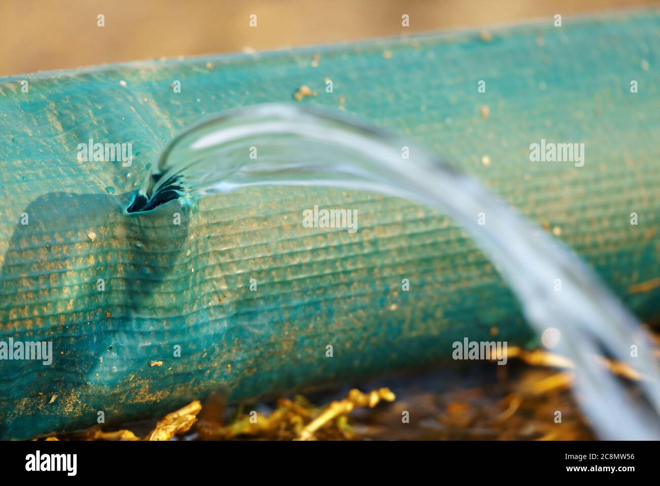 water leaking from hole in a industrial hose Stock Photo - Alamy