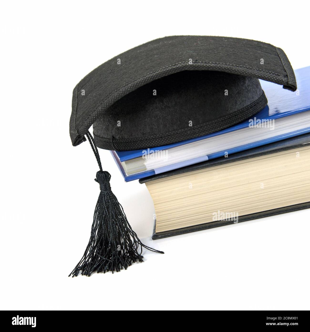 Doctor hat on books against white background Stock Photo - Alamy