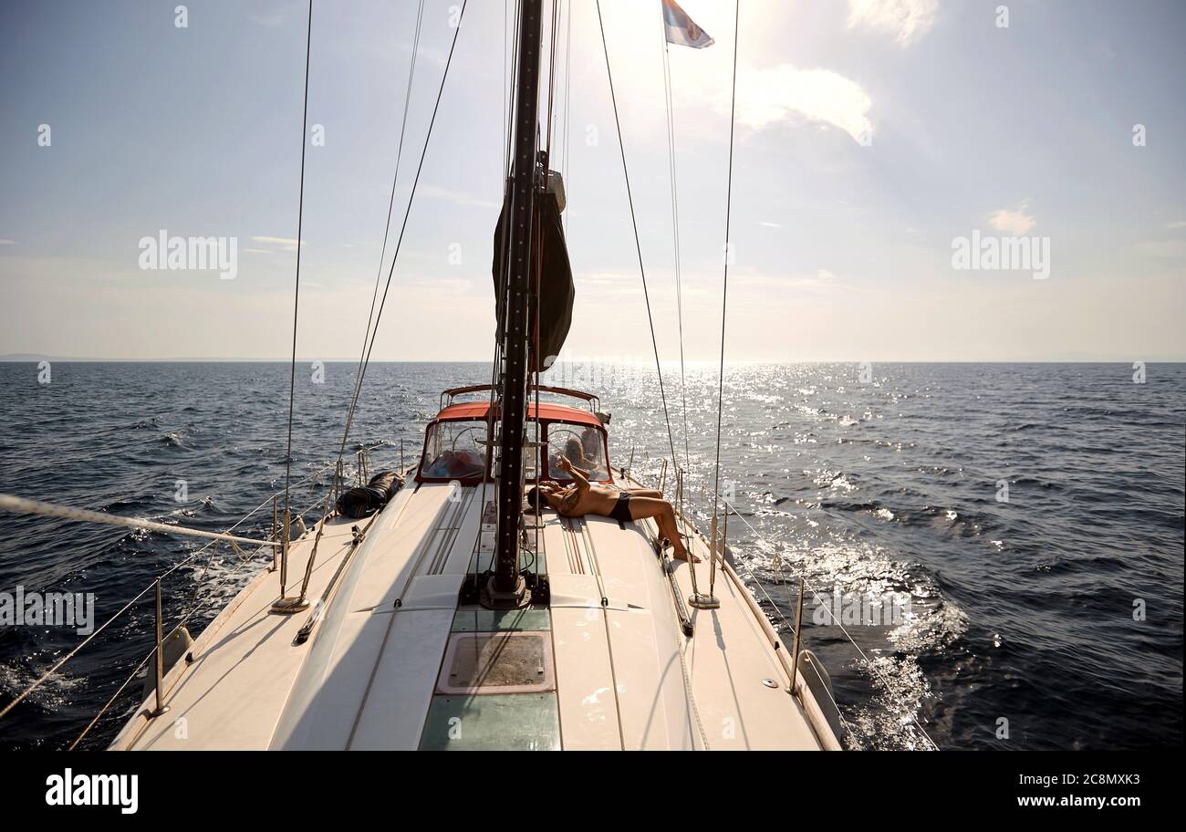 Woman sunbathing on sailboat hi-res stock photography and images - Alamy