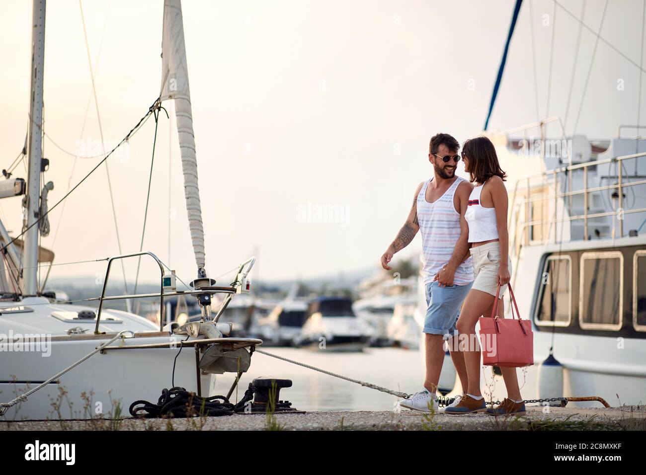 Couple in love enjoys a walk in the dock Stock Photo - Alamy