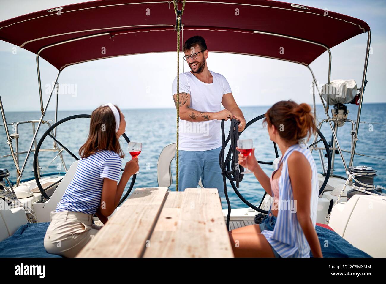 Friends chill on a yacht on open sea Stock Photo - Alamy