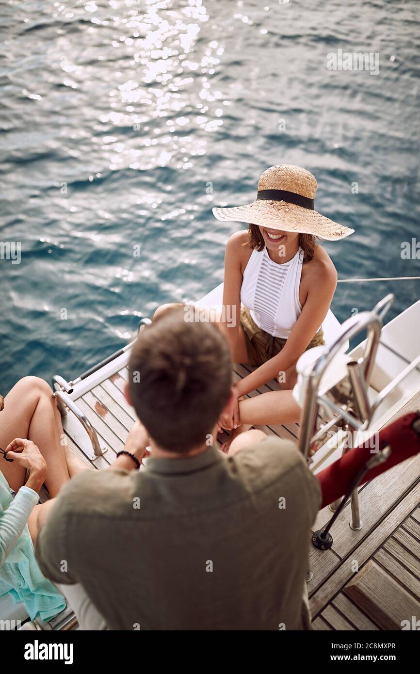 Friends enjoing the sunset on stern of a yacht on a wonderful weather ...