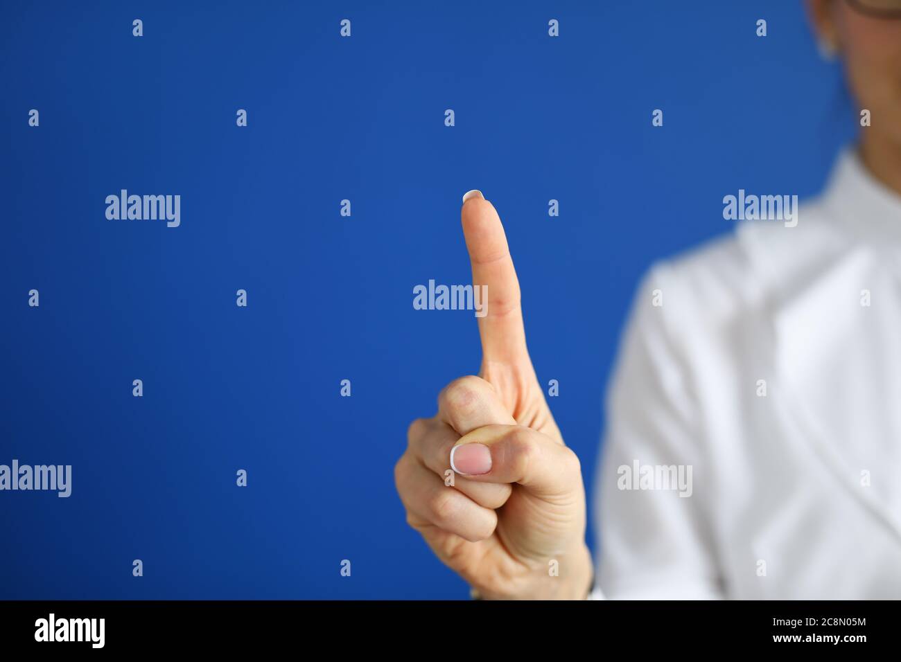 Woman show thumbs up on blue background Stock Photo - Alamy