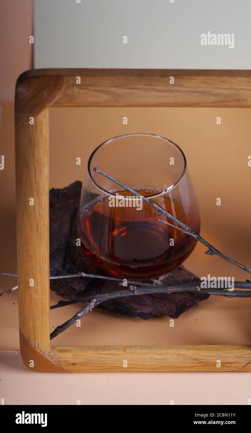 glass with brandy whiskey on natural background Stock Photo - Alamy