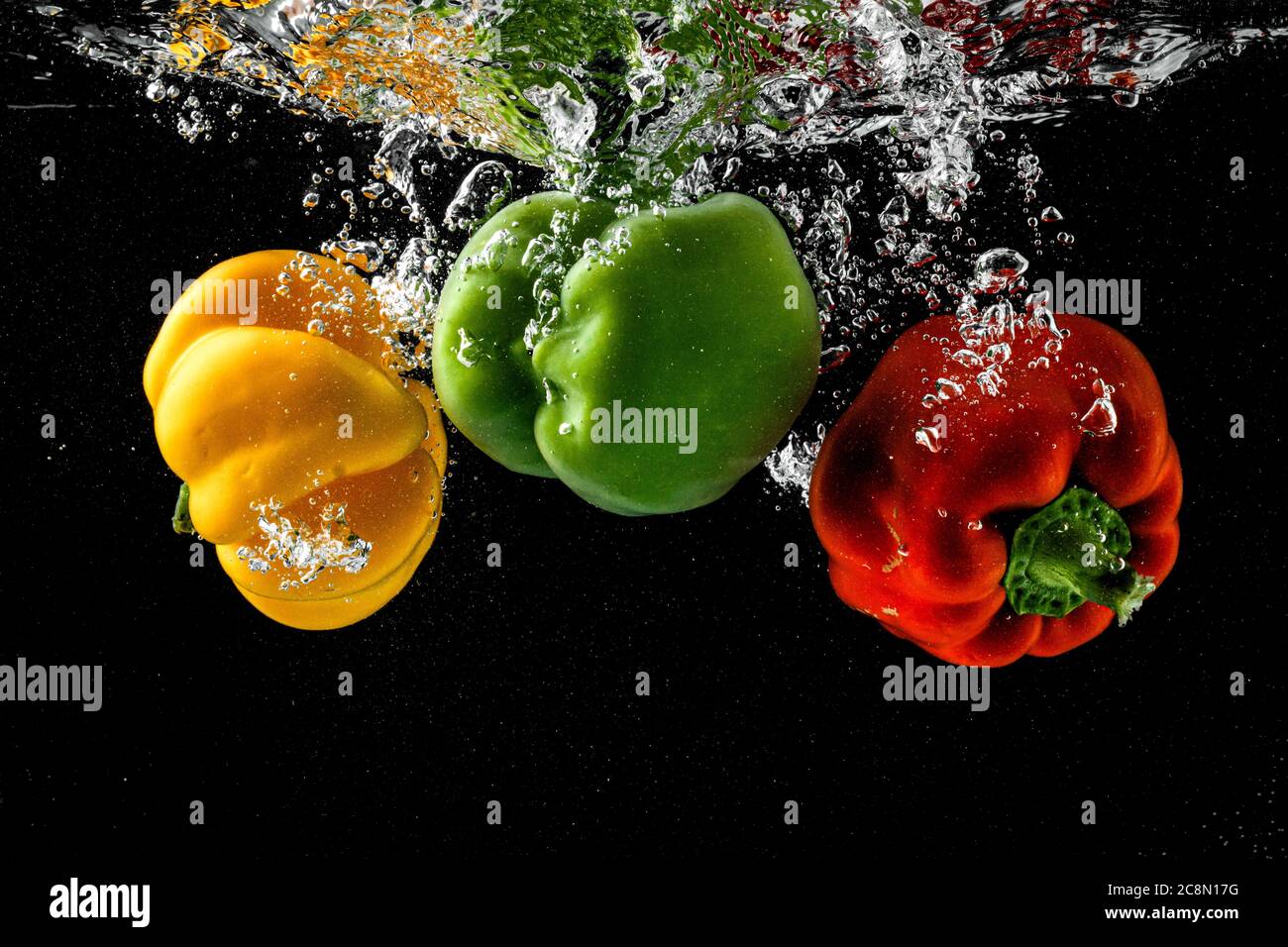 Three multi-colored bell peppers Stock Photo - Alamy