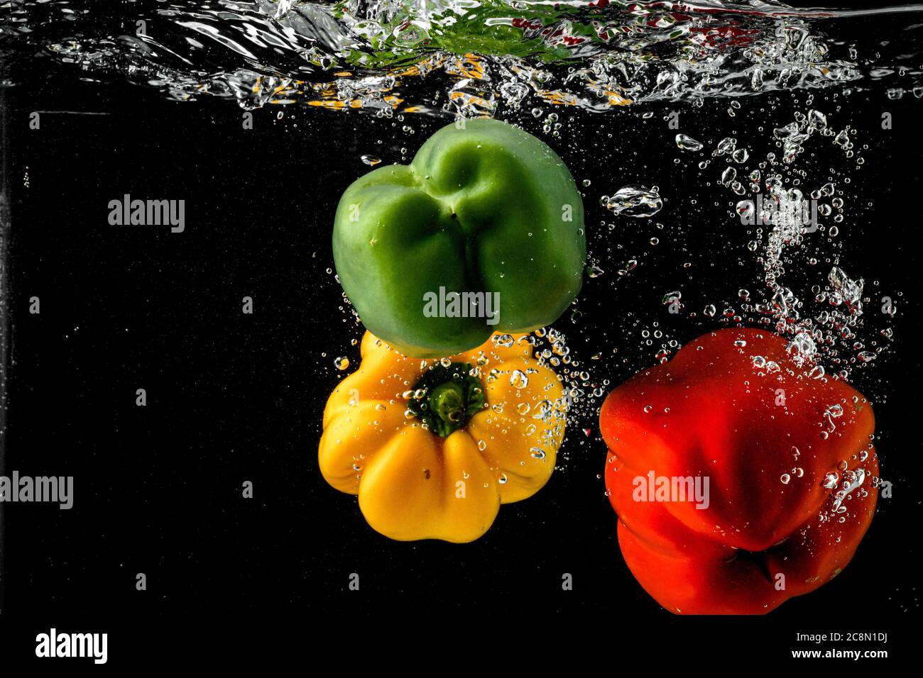 Three multi-colored bell peppers Stock Photo - Alamy