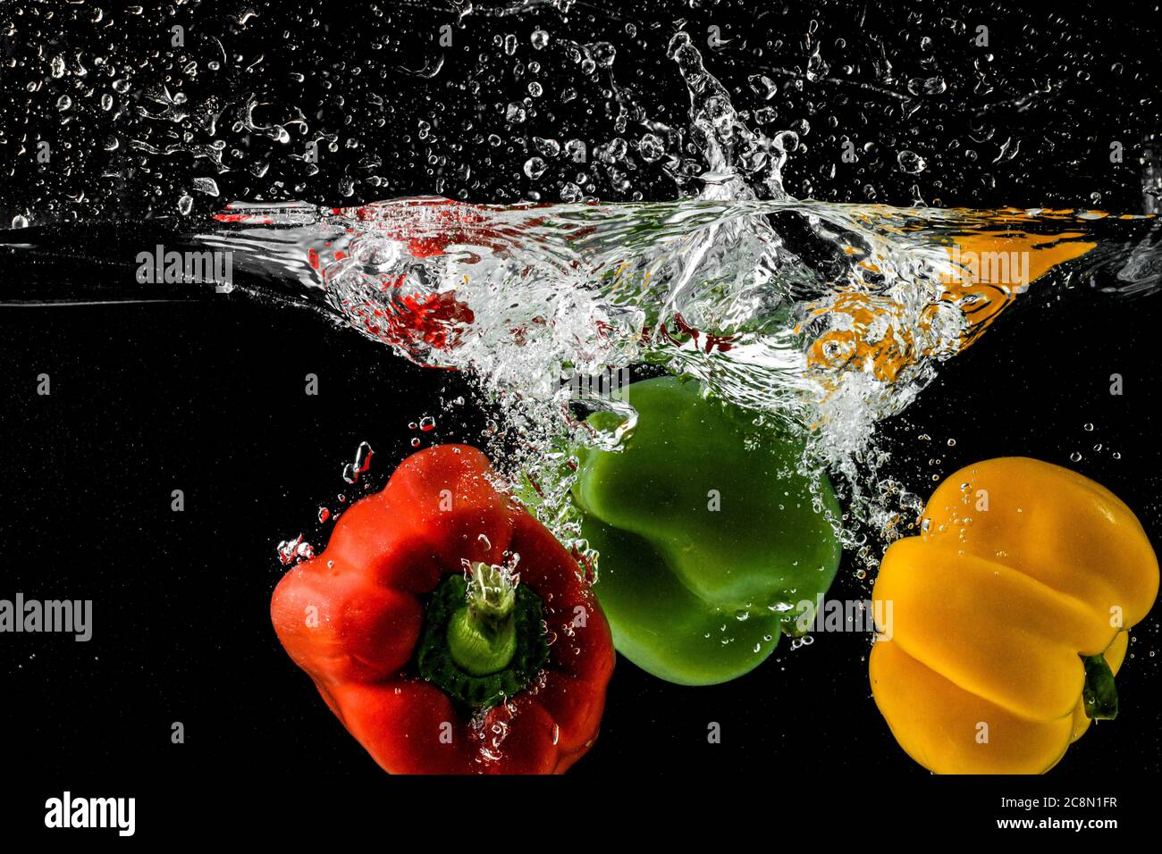 Three multi-colored bell peppers Stock Photo - Alamy