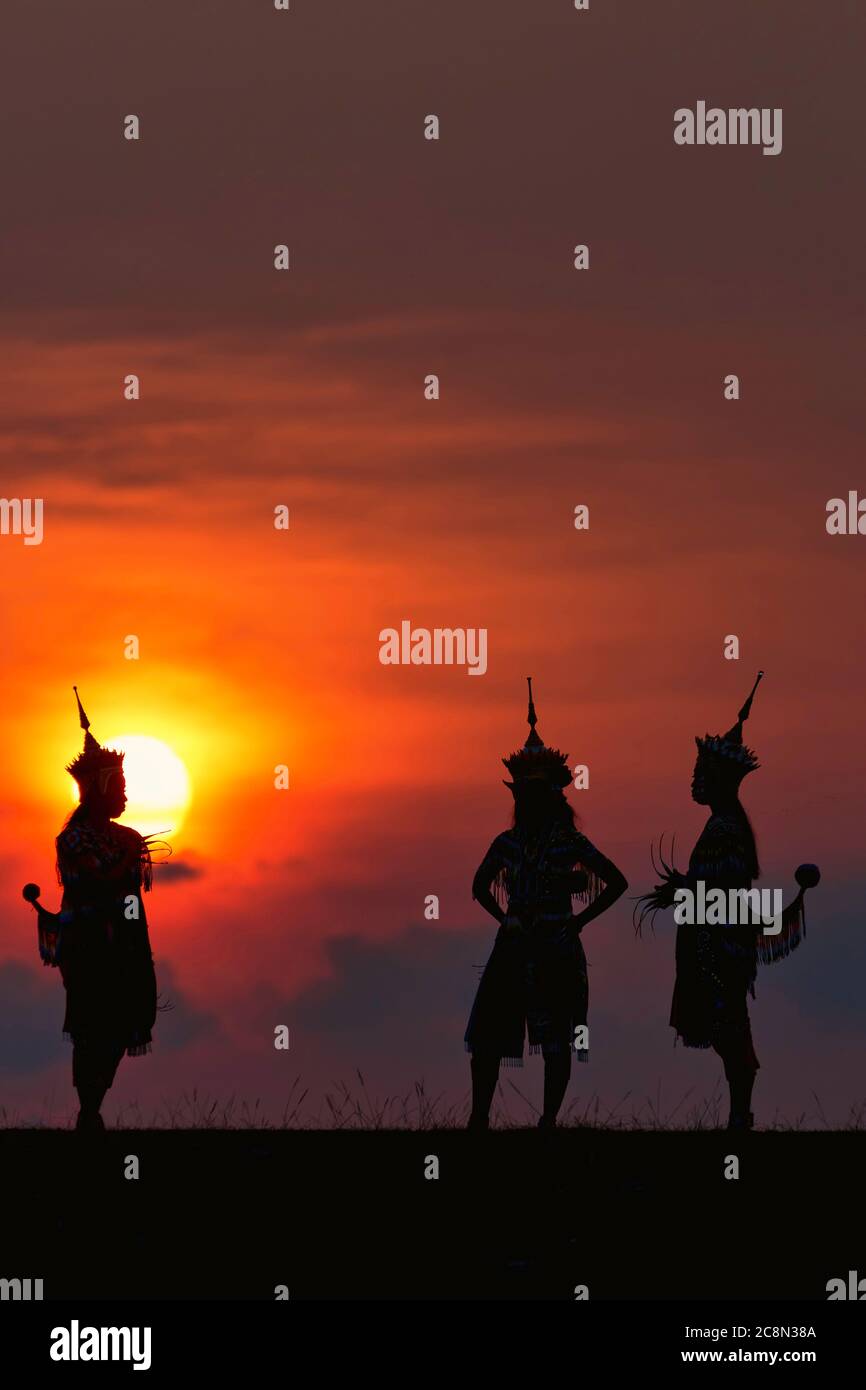 The black silhouette of three Manohra actors dancing in the park in the ...