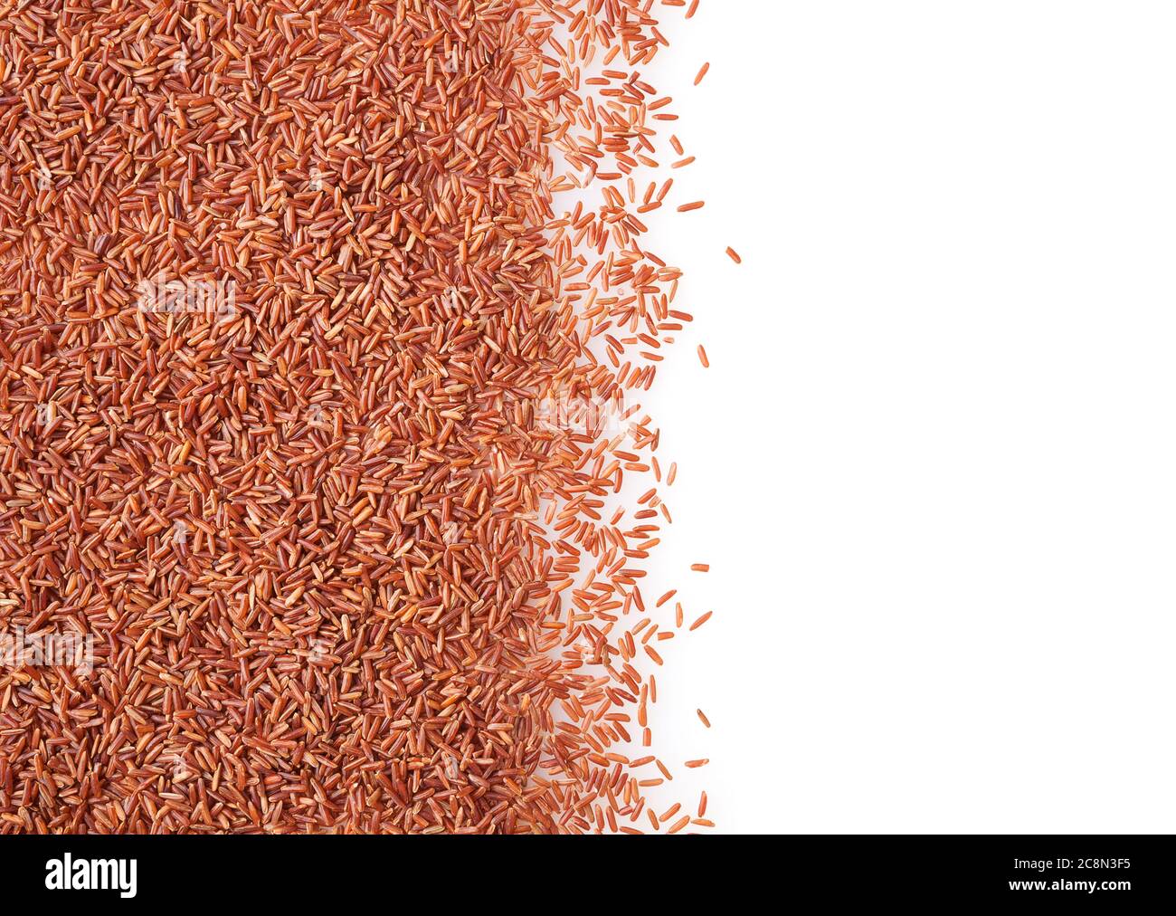 Uncooked red rice on white background with copy space Stock Photo - Alamy