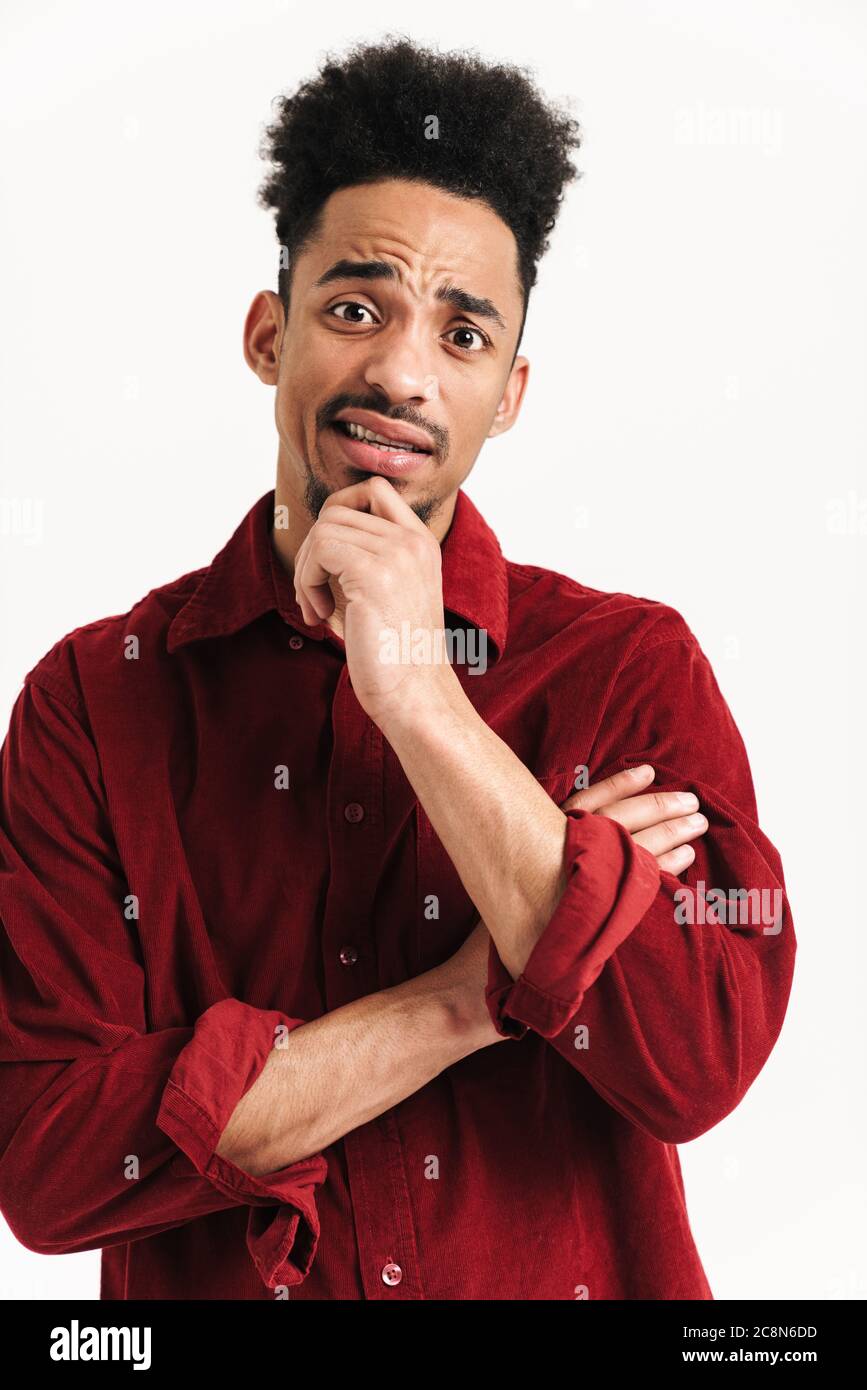 Image of a thinking confused african young man posing isolated over ...