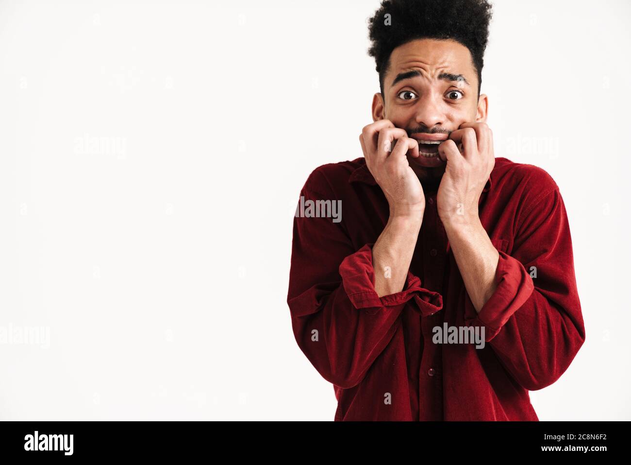Photo of scared african young man posing isolated over white wall ...