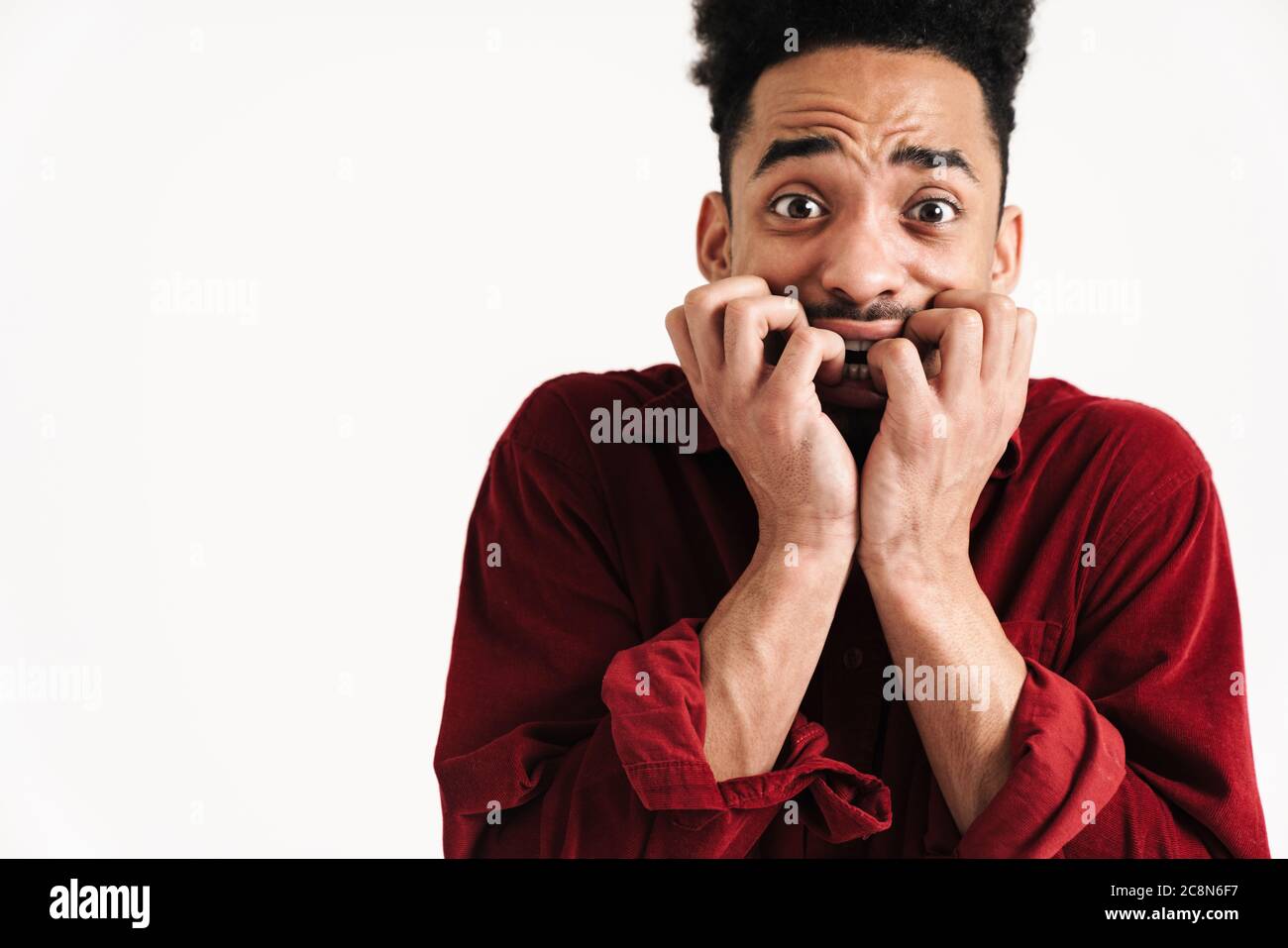 Photo of scared african young man posing isolated over white wall ...
